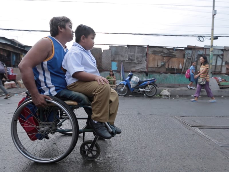 Photo Of A Father Driving His Son To School On A Wheelchair Went Viral ...